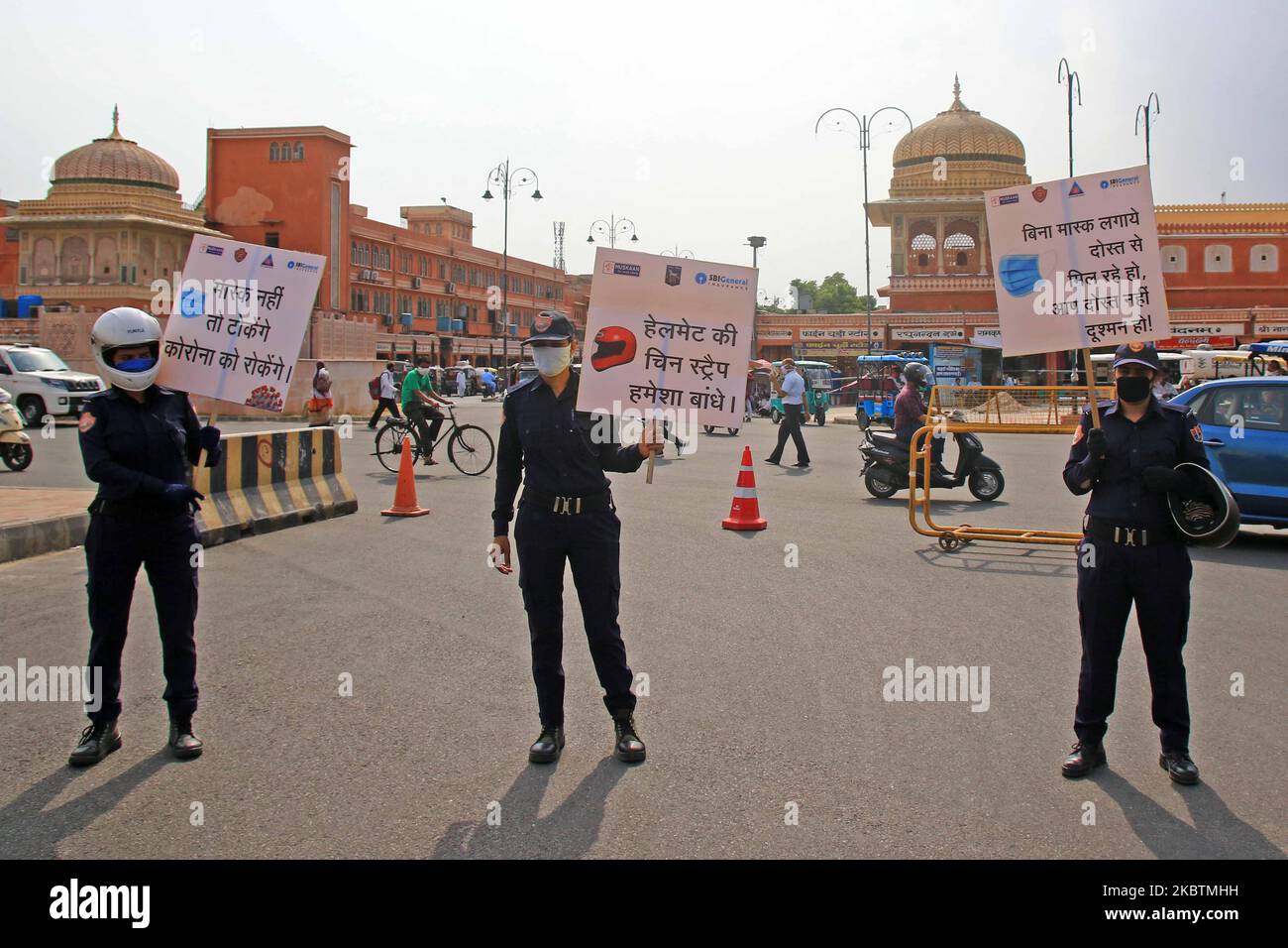 Security personnel hold placards to spread awareness on COVID-19 and ...