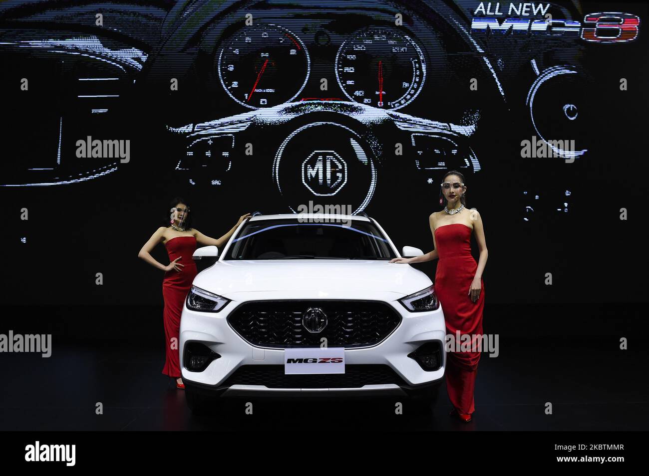 Models wearing face shields pose next a MG cars during the 41st Bangkok ...