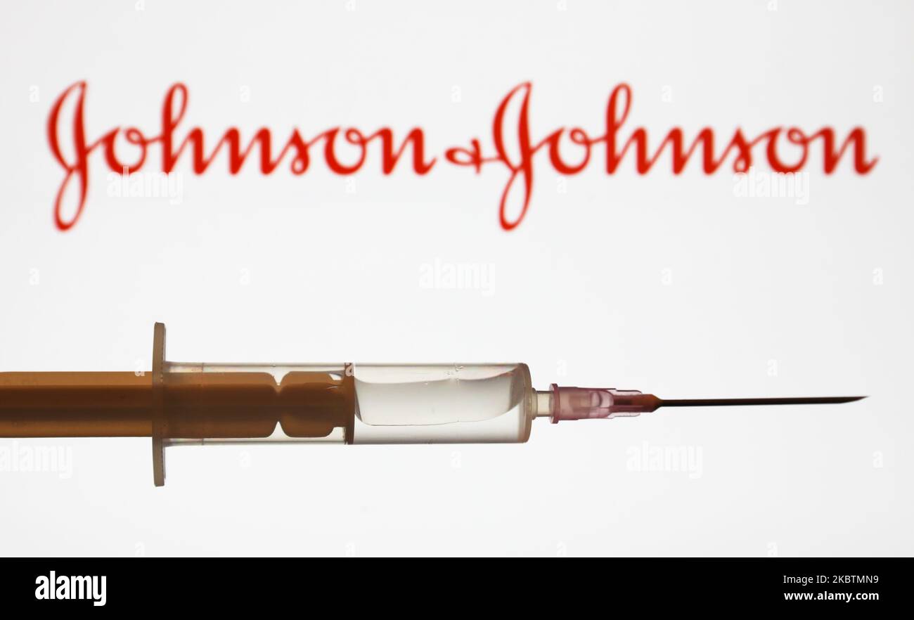Medical syringe is seen with Johnson & Johnson company logo displayed ...