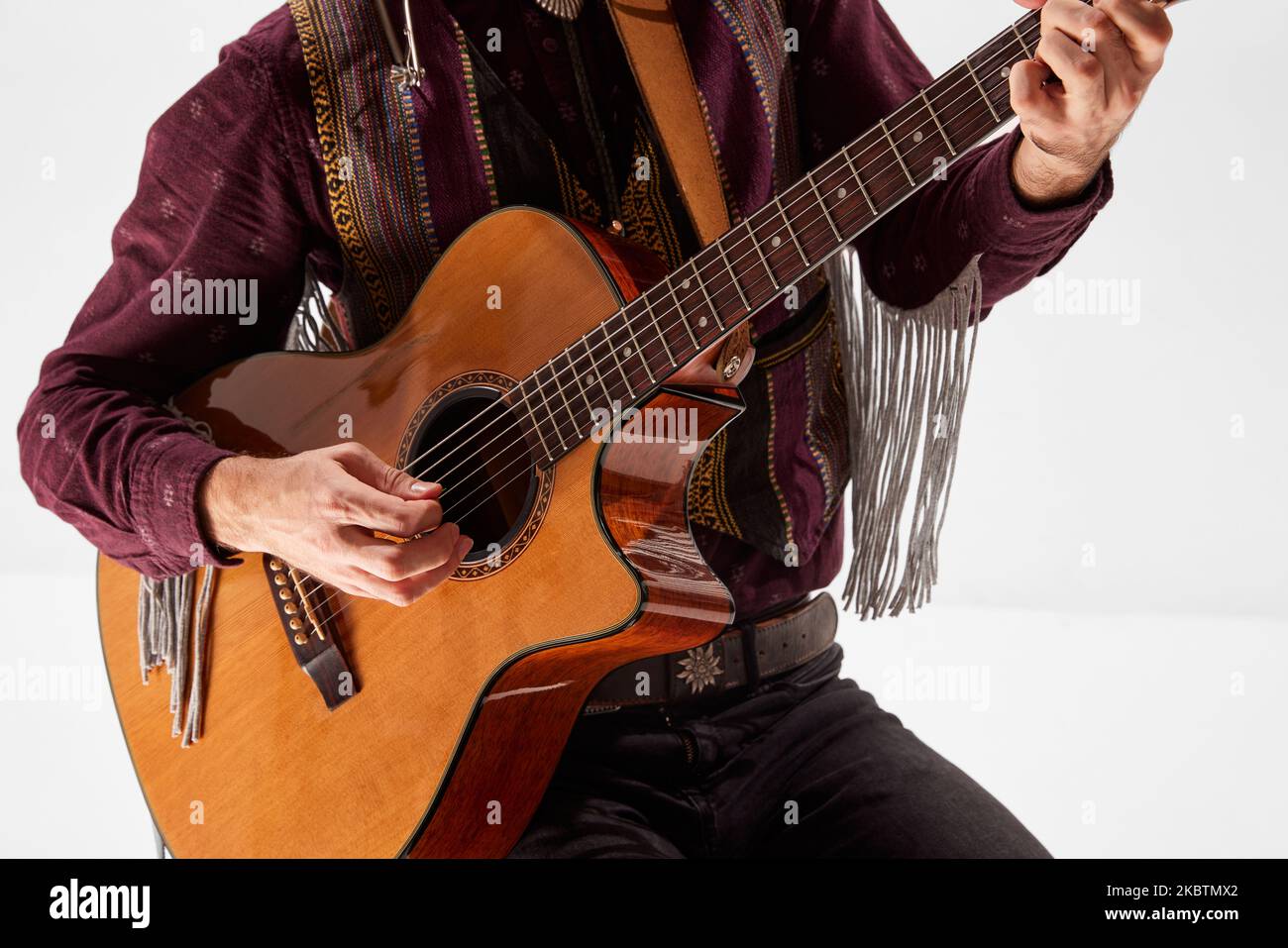 Cropped image of man in vintage cowboy style clothes playing guitar ...