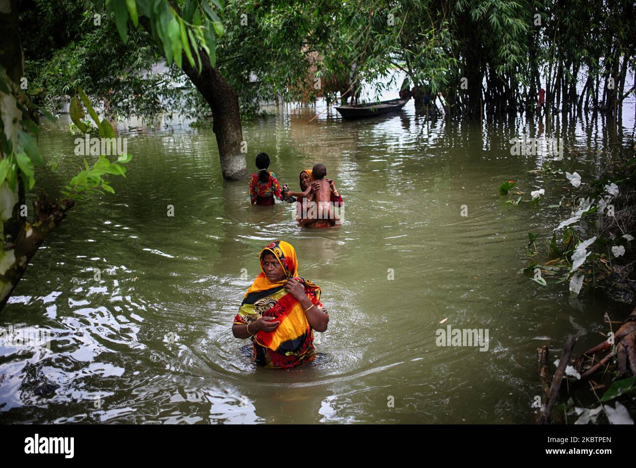 Women walk through flood water in Panchgachi, Kurigram on Friday, July ...
