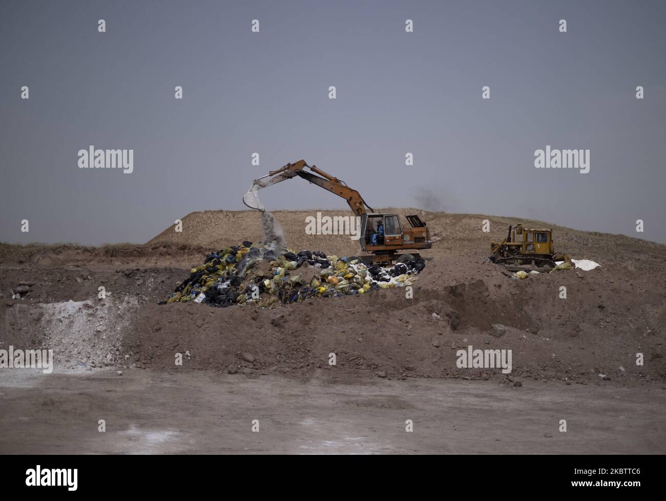 A loader covers infectious wastes with lime in Tehran Garbage Disposal ...
