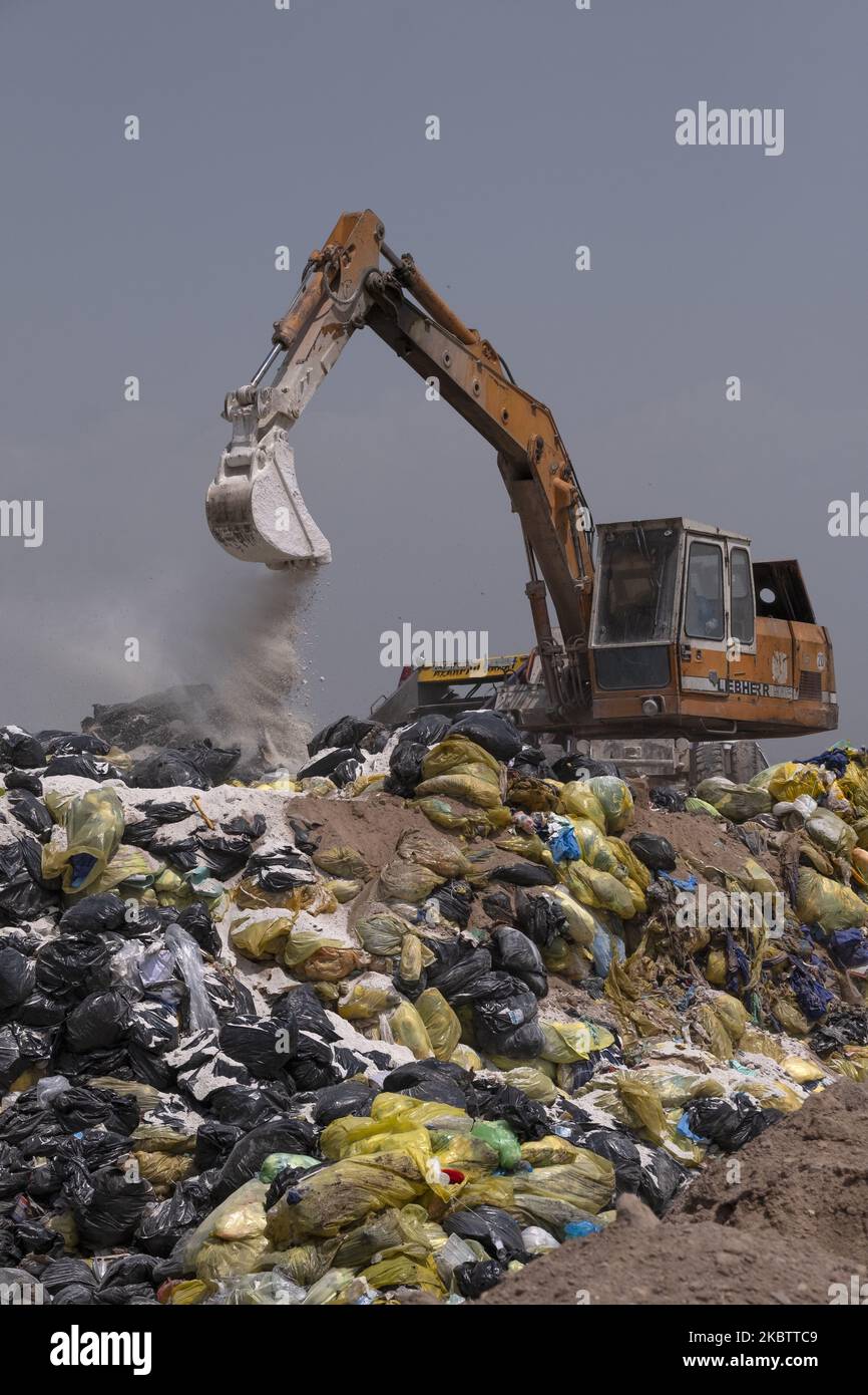 A loader covers infectious wastes with lime in Tehran Garbage Disposal ...