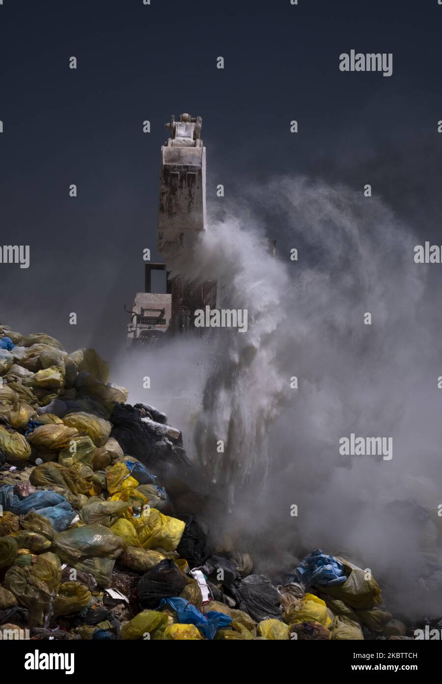 A loader covers infectious wastes with lime in Tehran Garbage Disposal ...