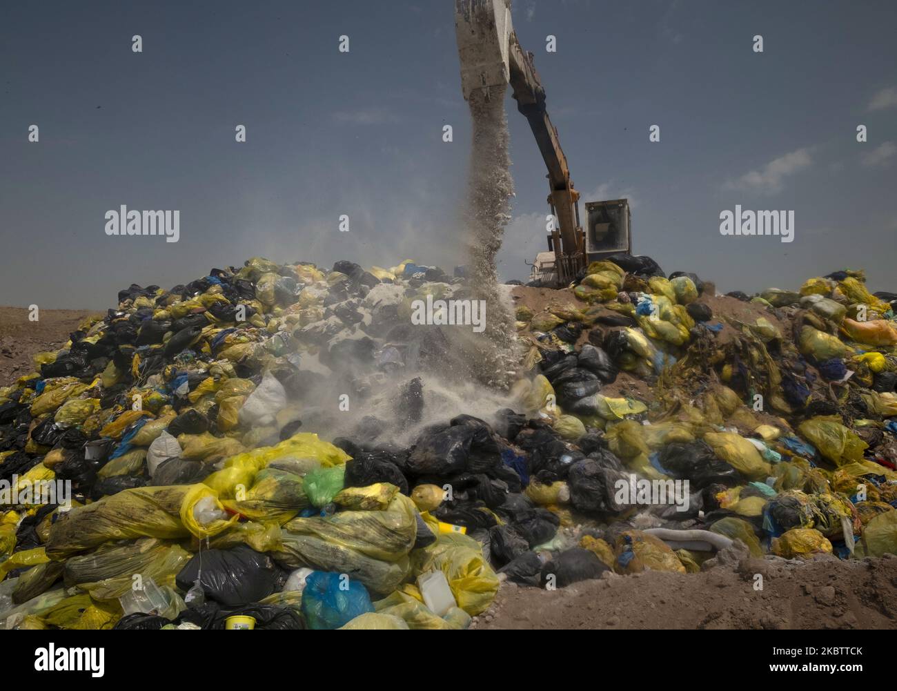 A loader covers infectious wastes with lime in Tehran Garbage Disposal ...