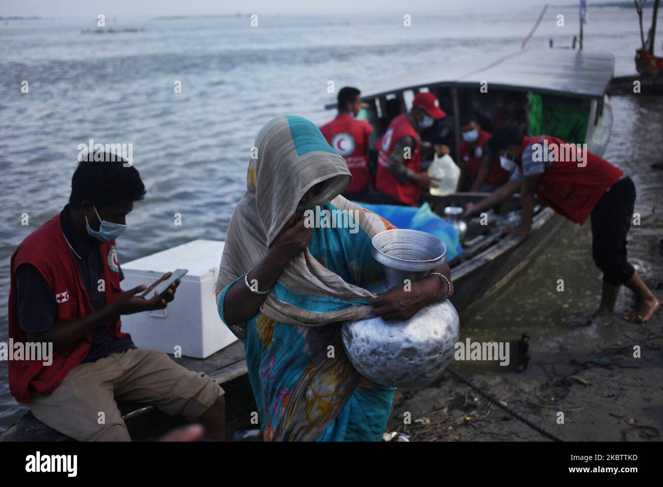 Flood-affected people collect pure drinking water from Bangladesh Red ...
