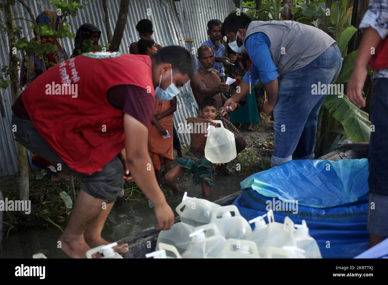 Flood-affected people collect pure drinking water from Bangladesh Red ...