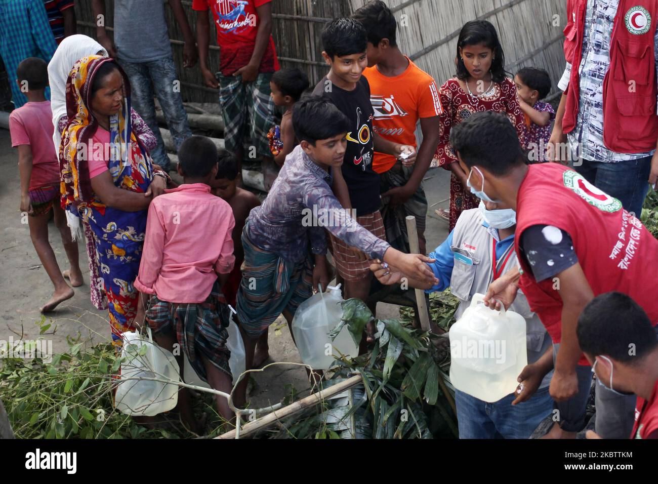 Flood-affected people collect pure drinking water from Bangladesh Red ...