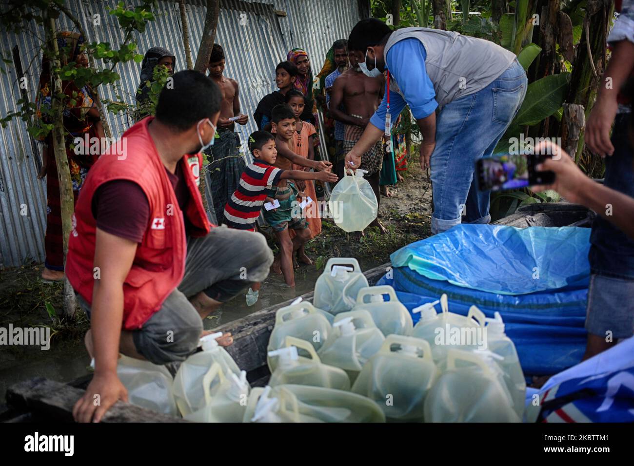 Flood-affected people collect pure drinking water from Bangladesh Red ...