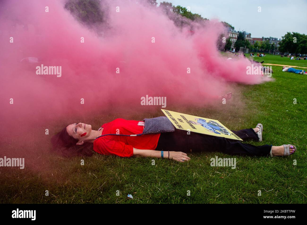 The climate activists are carrying out a Die-In action also with red ...