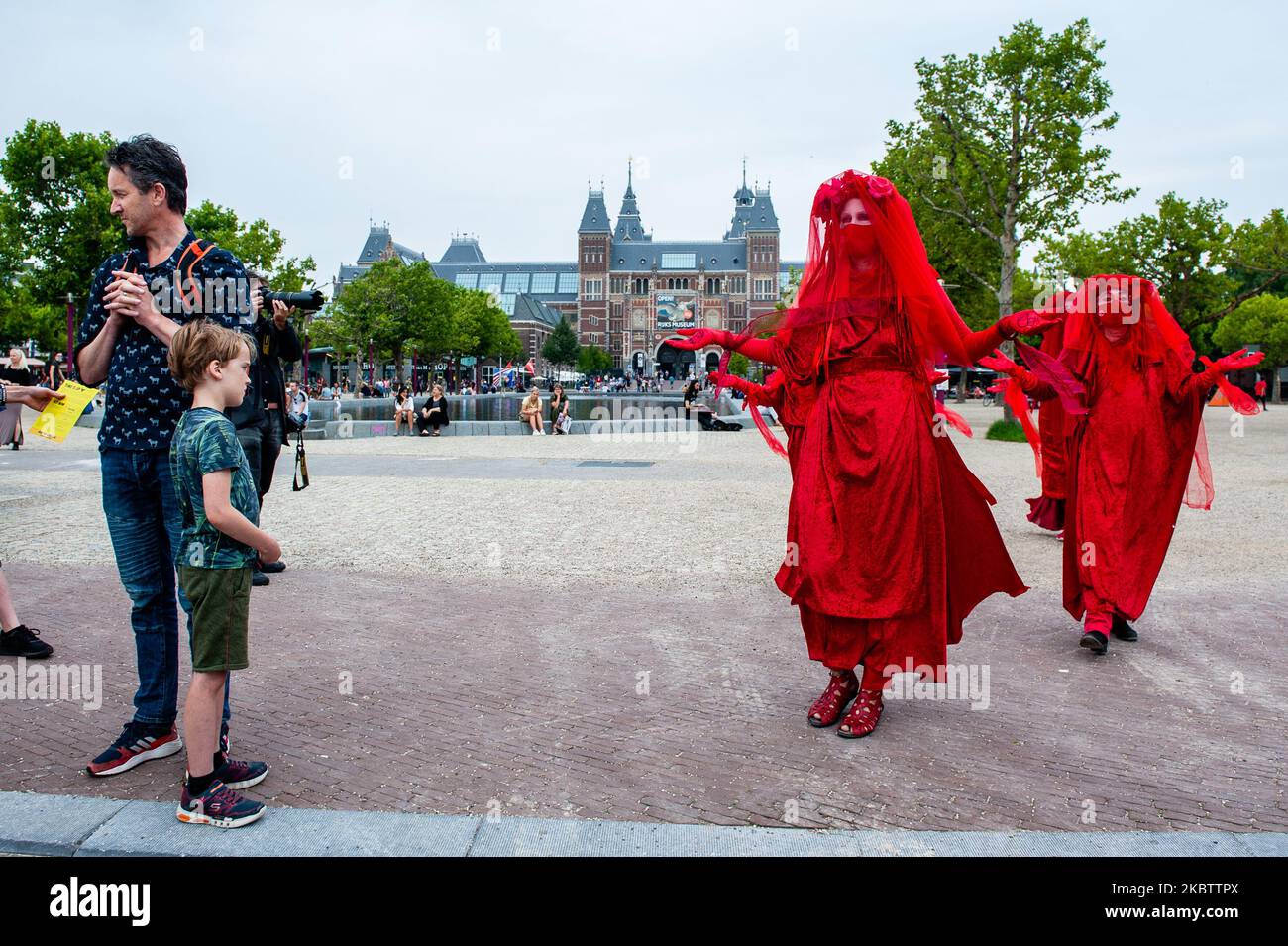 A boy is looking at the Red Rebels while they are arriving to the ...