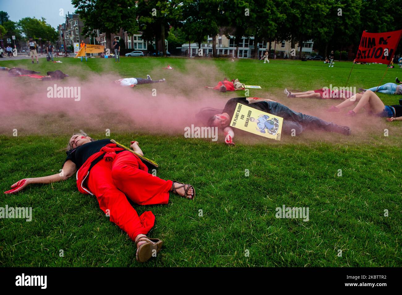 The climate activists are carrying out a Die-In action also with red ...