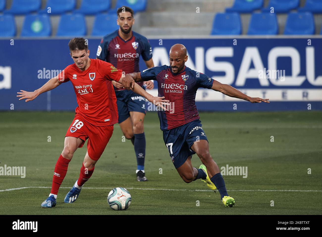 Igor Zlatanovic of Numacia and Mikel Rico of Huesca compete for the ...