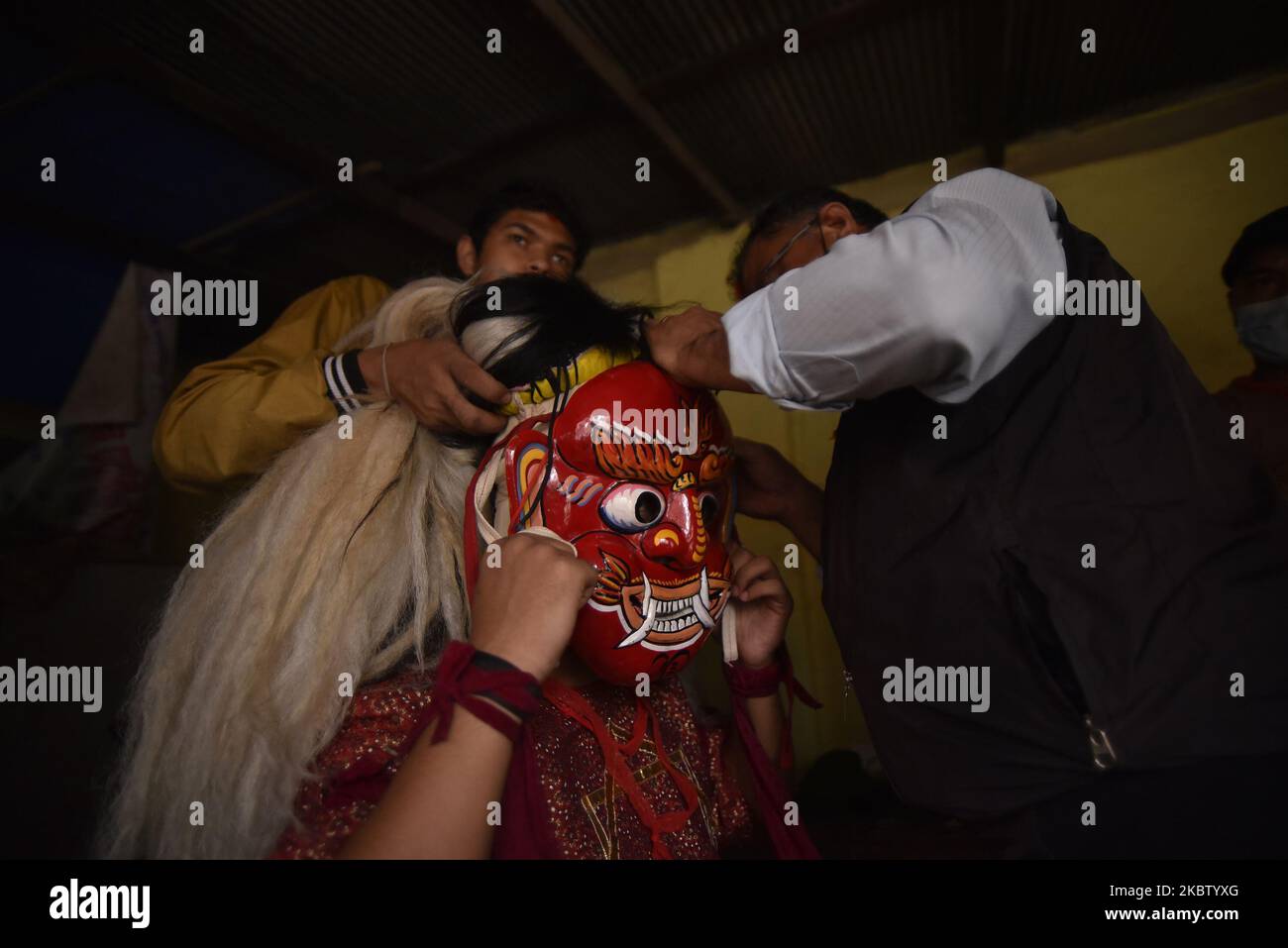 Nepalese devotees helps Lakhay to wear traditional attire to perform ...