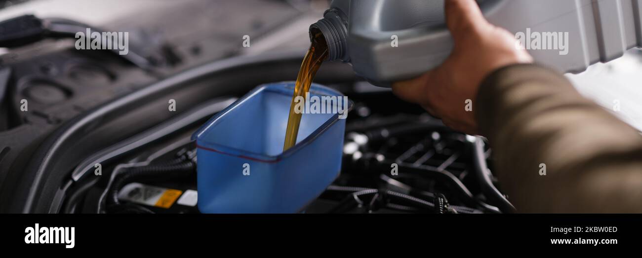 Refueling with fresh engine oil car engine Stock Photo - Alamy
