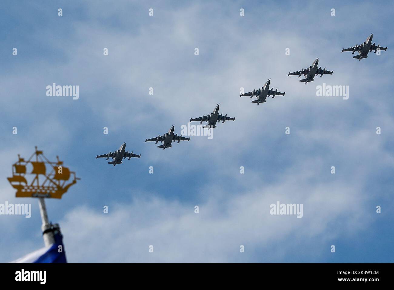 Navy planes fly in formation over a ship-shaped decoration on top of a ...