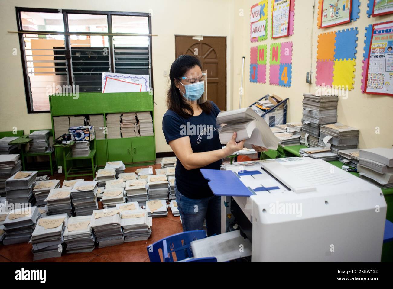 A teacher volunteers to photocopy learning materials to be used by ...