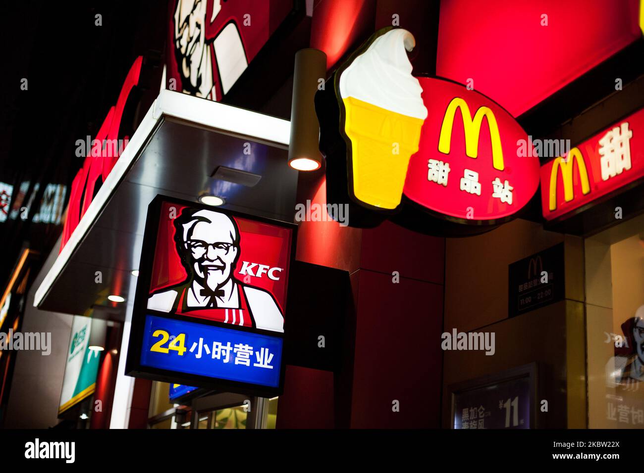 An illuminated sign of the McDonald's fast food chain and KFC in a ...