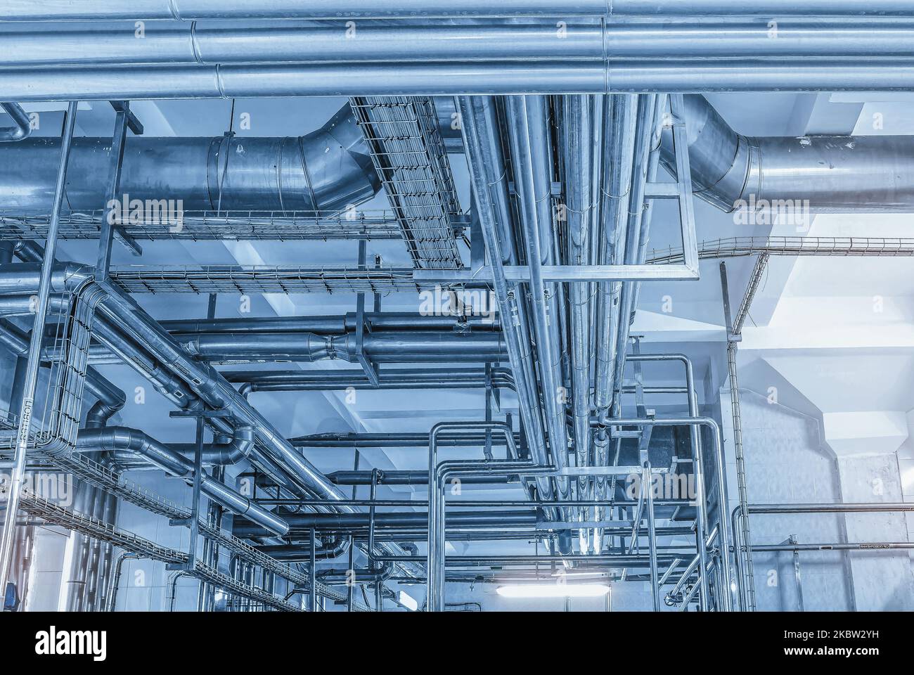 Metal pipes under ceiling of the milk production plant Stock Photo - Alamy