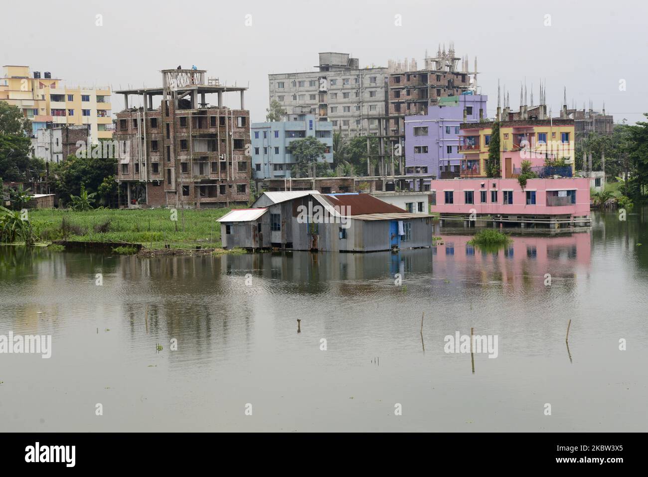 A view of flooded affected houses of Lowlands area of the Dhaka City ...