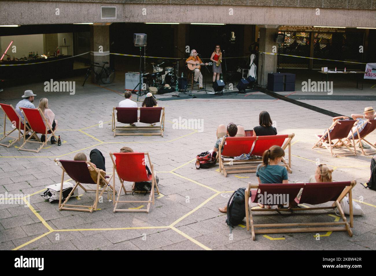 open air outdoor concert held as peeople are seen seating within social ...