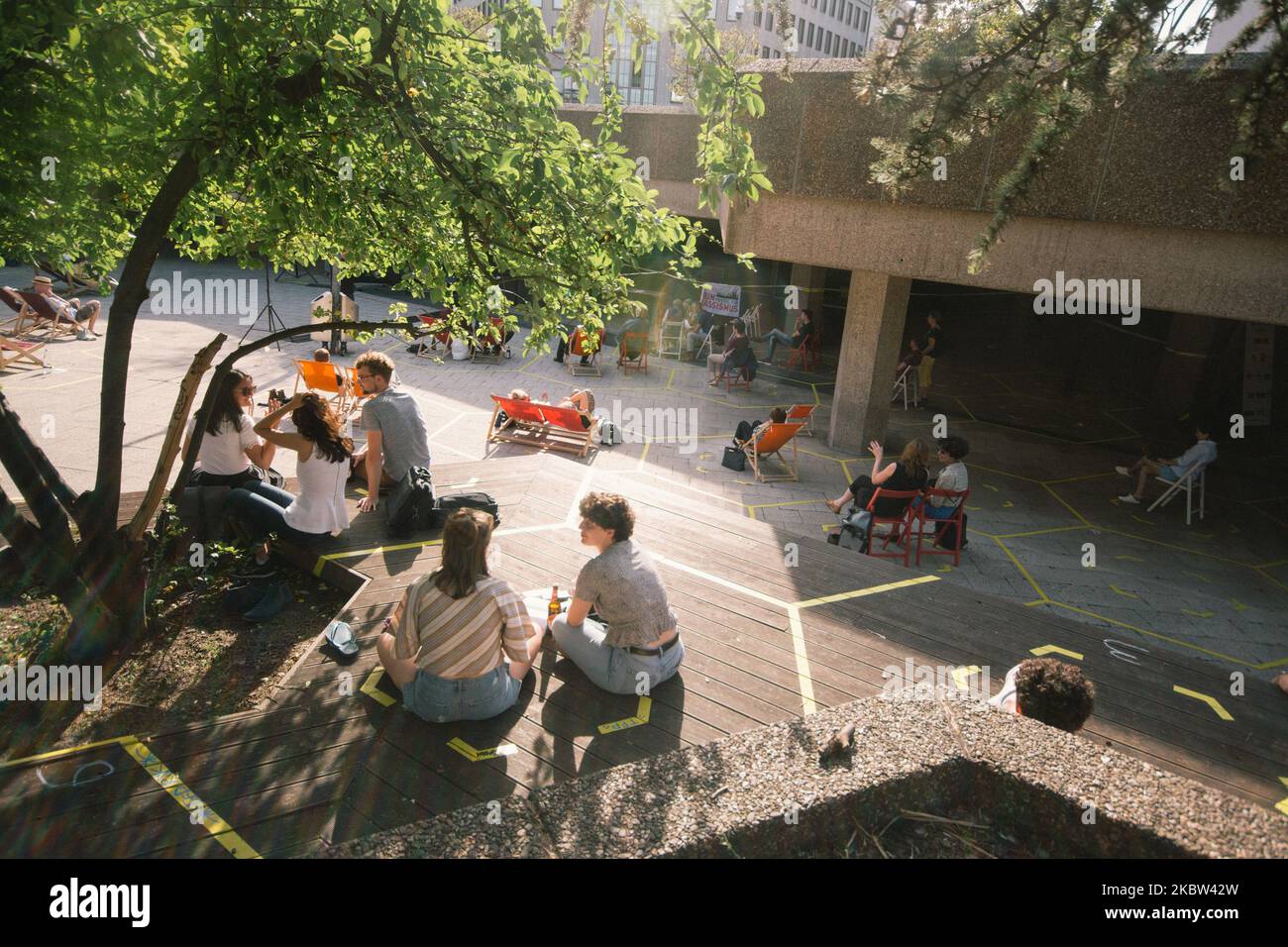 open air outdoor concert held as peeople are seen seating within social ...