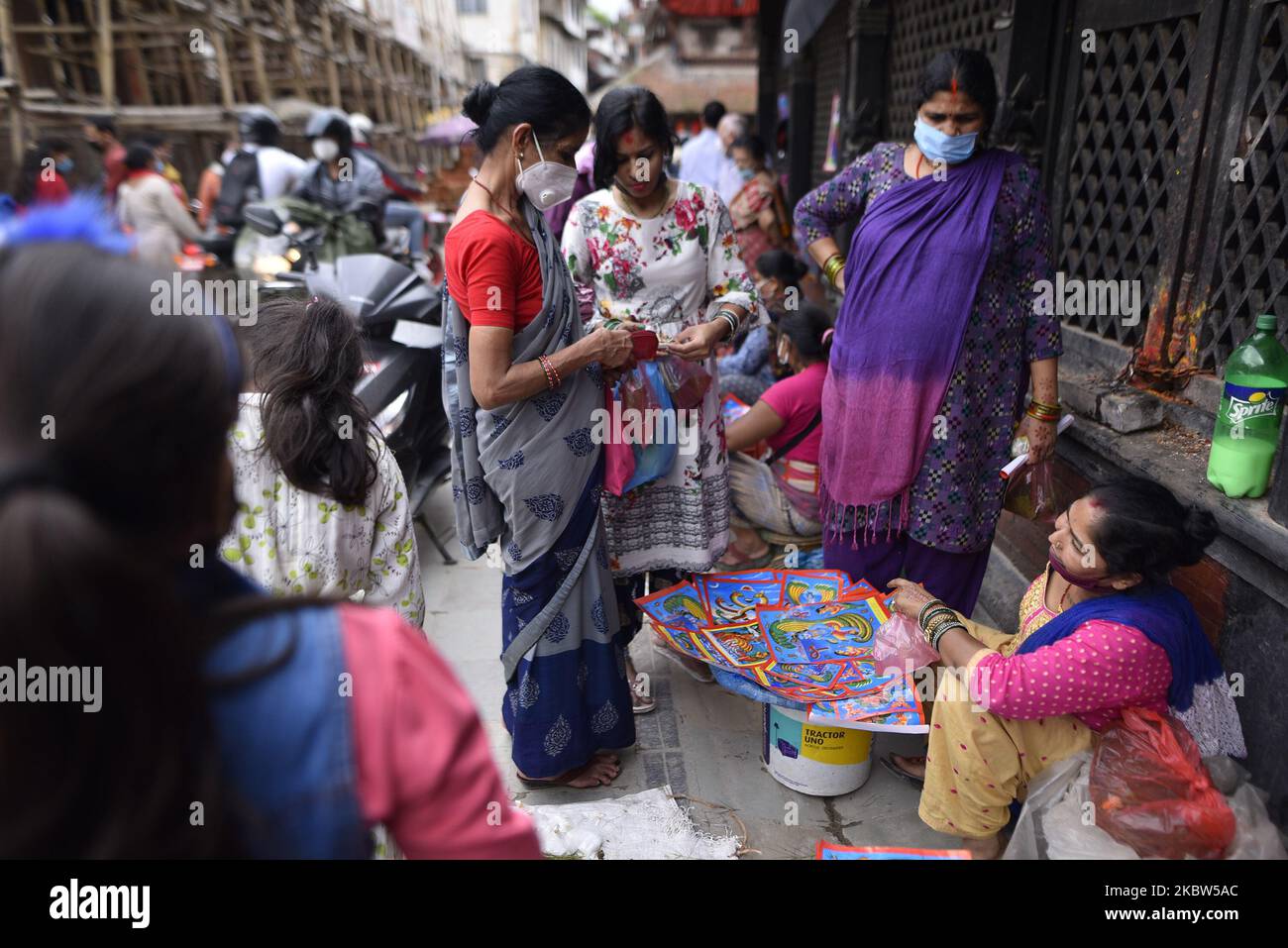A Nepalese devotee selects Nag Poster for the celebration of Nag ...
