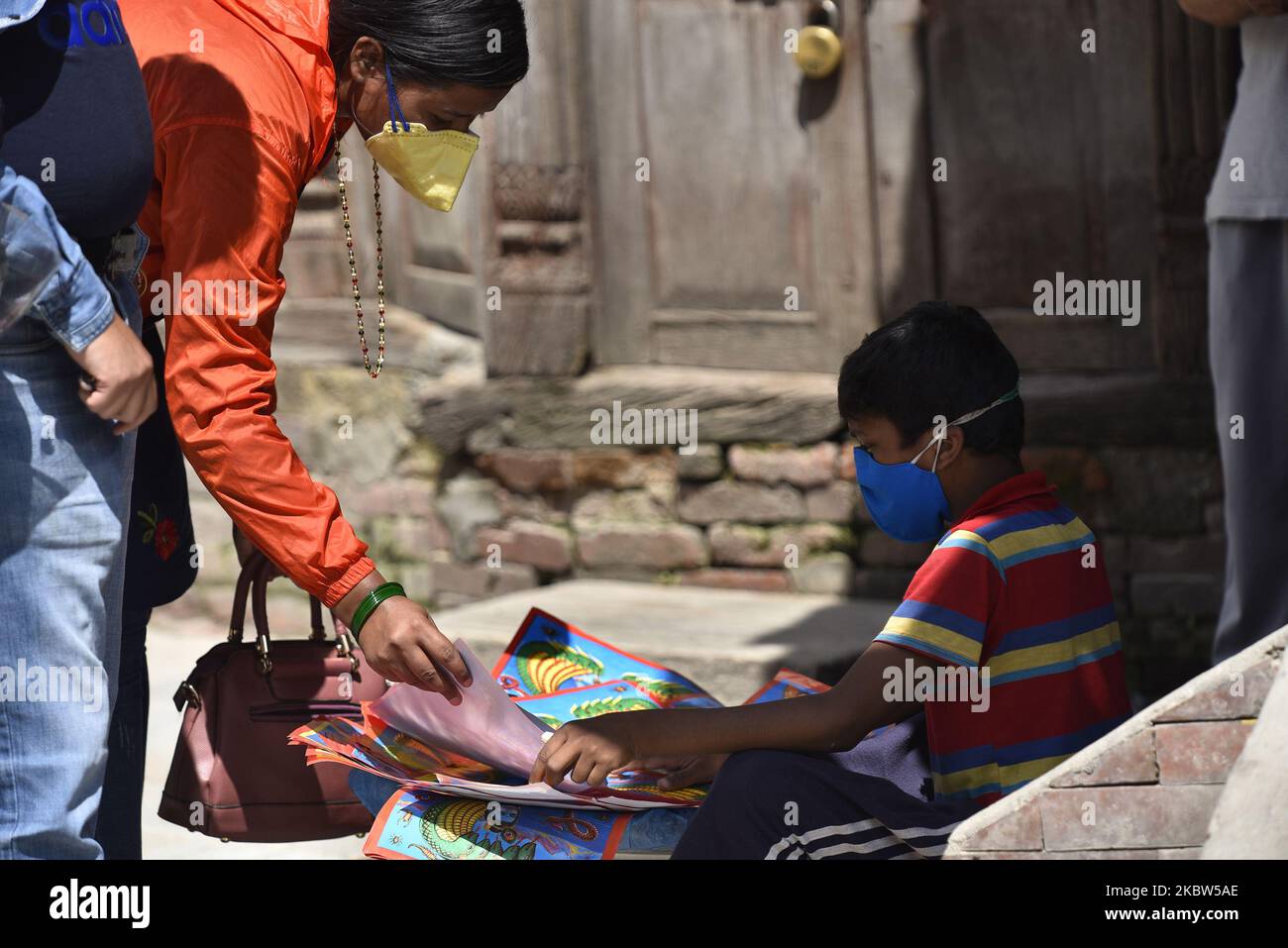 A Nepalese devotee selects Nag Poster for the celebration of Nag ...