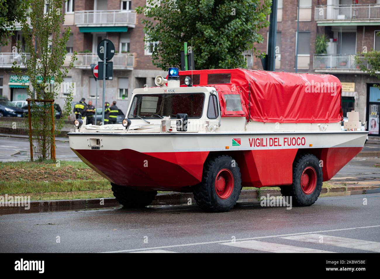 Firemen rescue vehicles during storm and flooding of the Seveso river ...