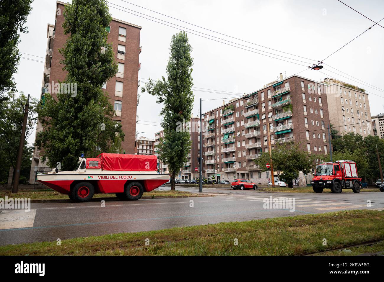 Firemen rescue vehicles during storm and flooding of the Seveso river ...