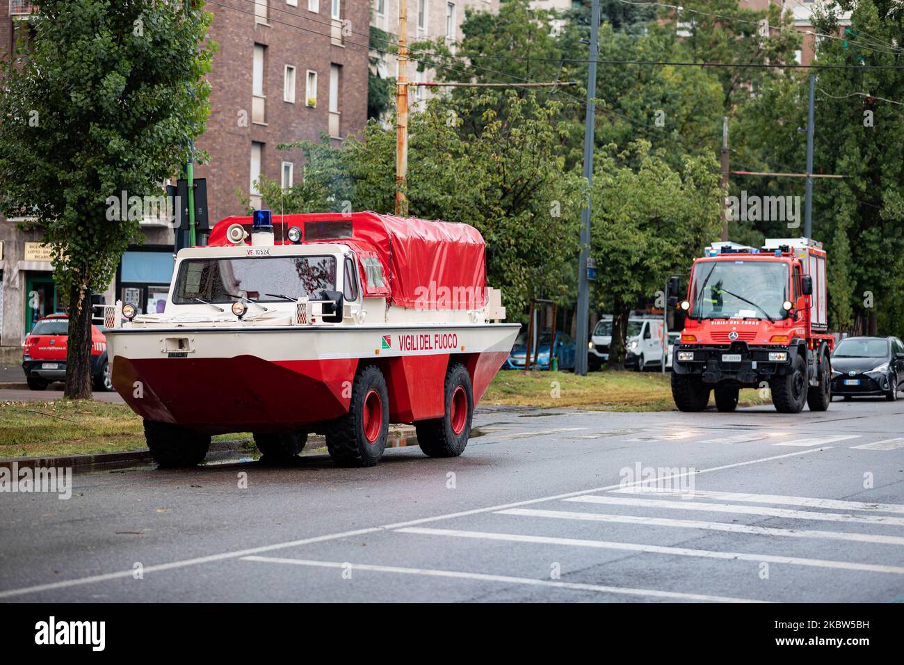 Firemen rescue vehicles during storm and flooding of the Seveso river ...