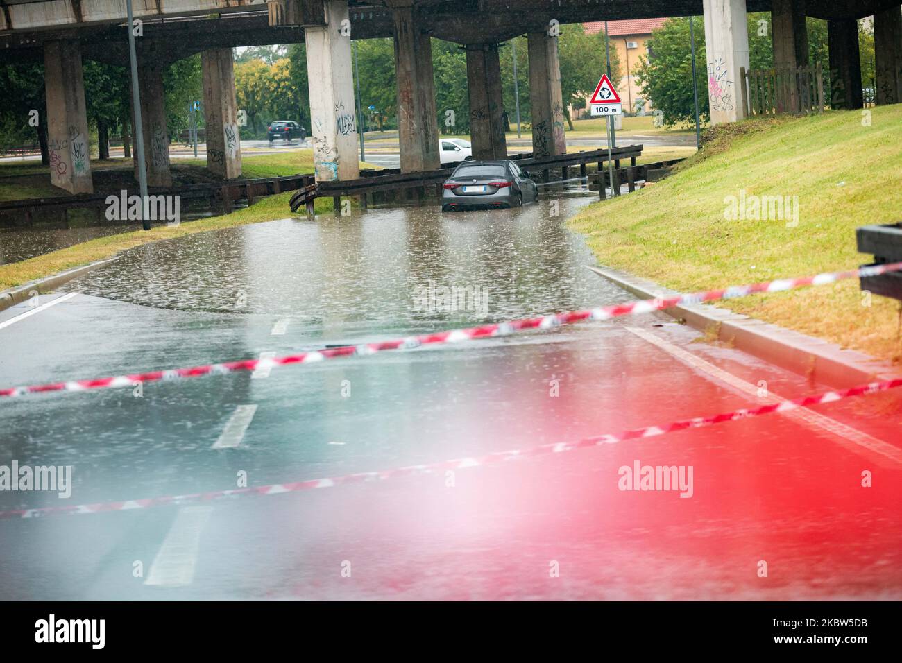 A car in high water during storm and flooding of the Seveso river on ...