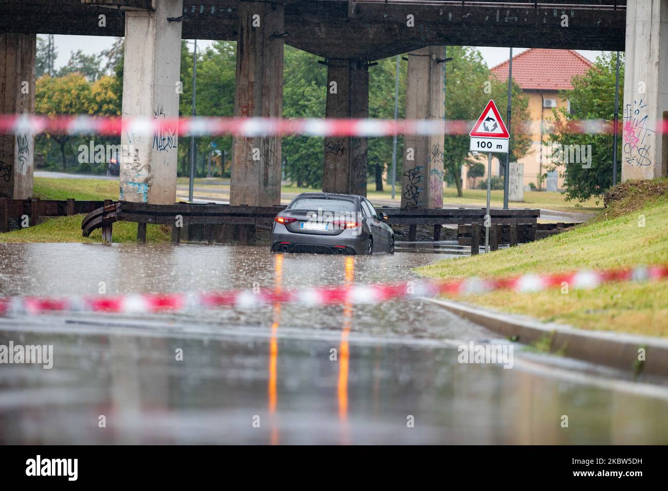 A car in high water during storm and flooding of the Seveso river on ...