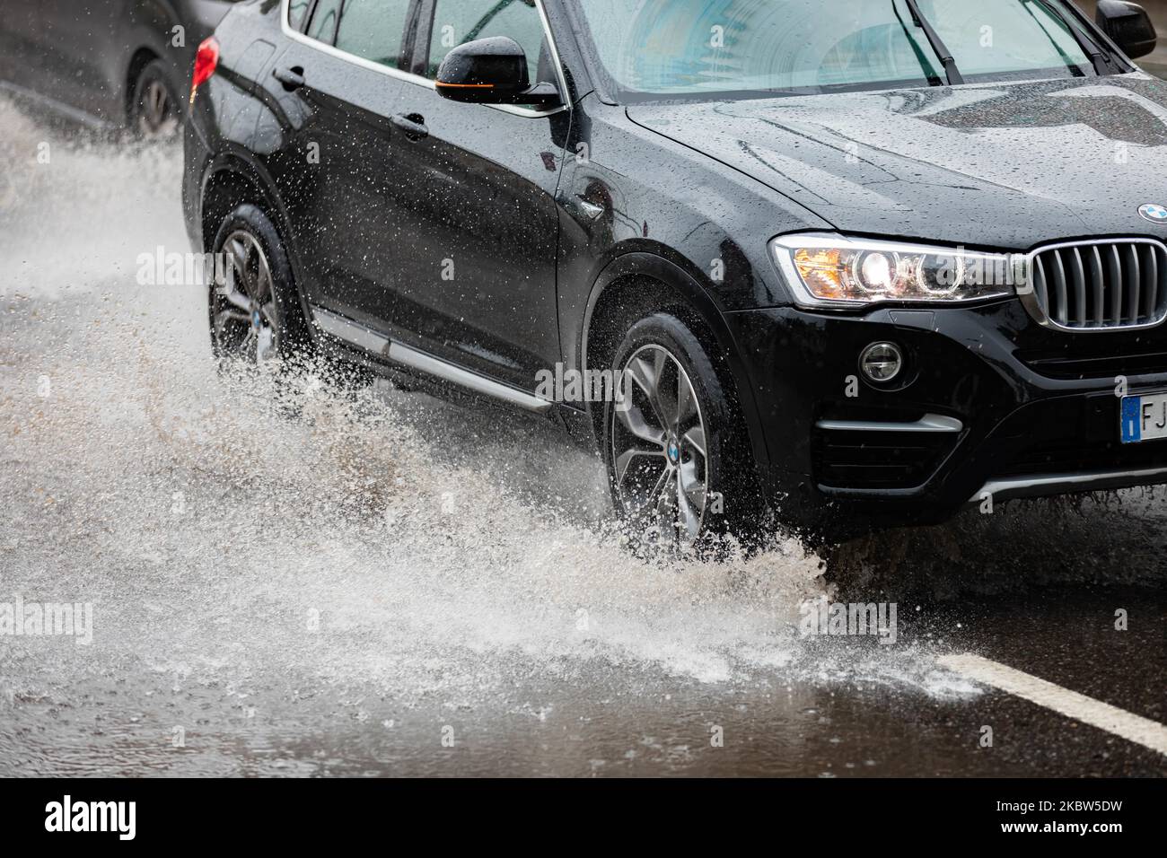 A car in high water during storm and flooding of the Seveso river on ...