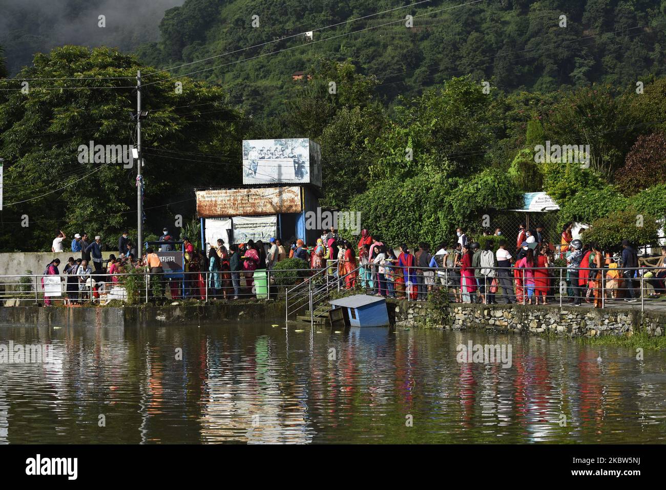 Nepalese devotees lined up to offer ritual prayer towards Nag or Snake ...