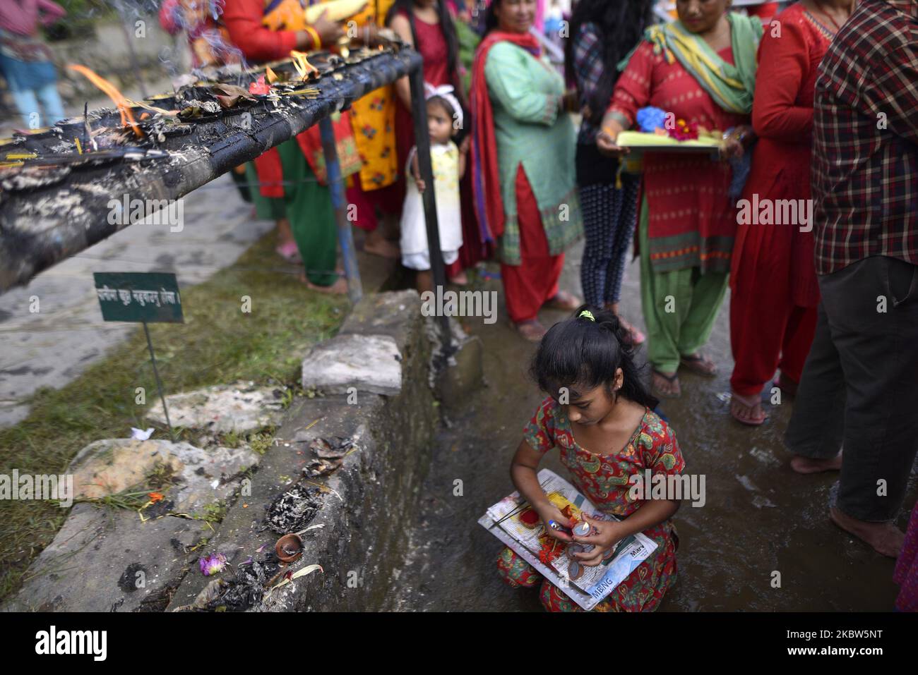 A Little girl offering ritual prayer towards Nag or Snake God at ...