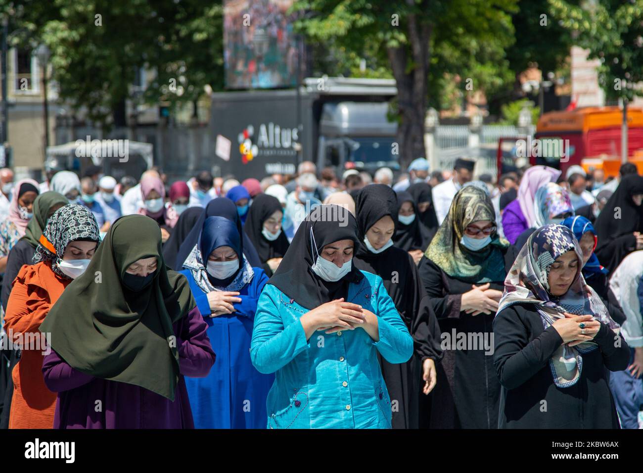 Muslims pray the noon prayer outside the Hagia Sophia Mosque on July 25 ...