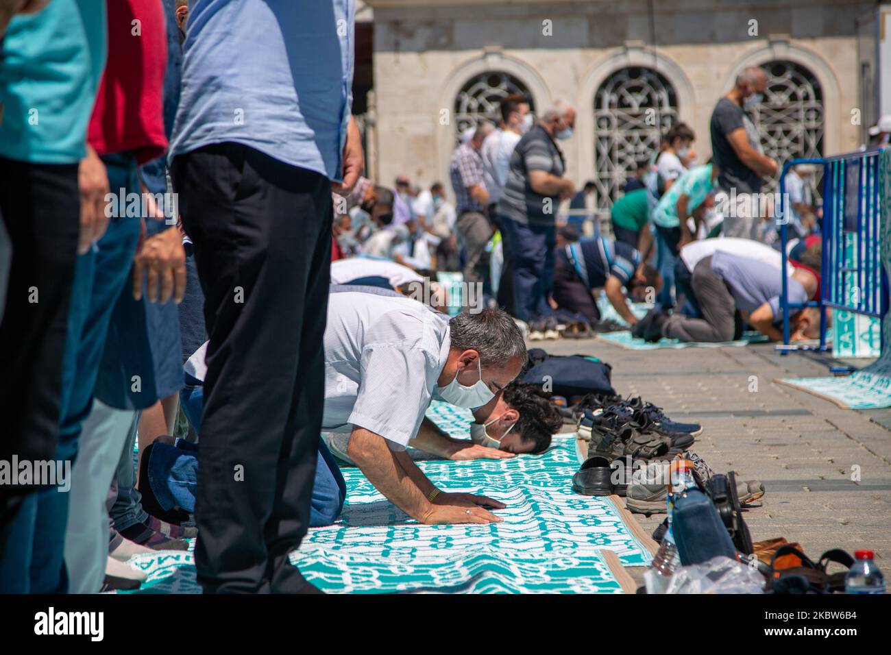 Muslims pray the noon prayer outside the Hagia Sophia Mosque on July 25 ...