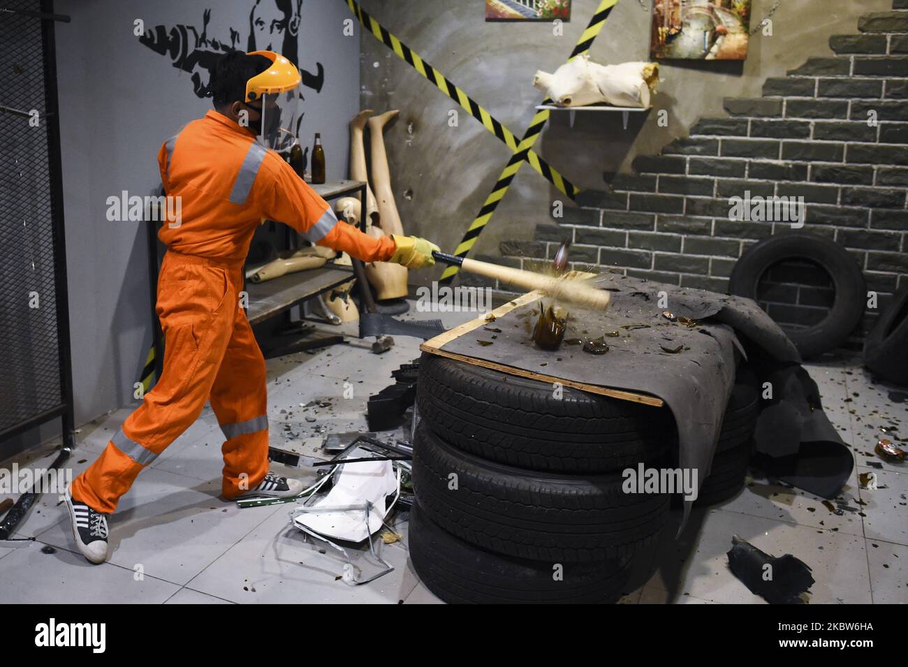 People take part in a "Rage Room" smashes bottles to vent anger and ...