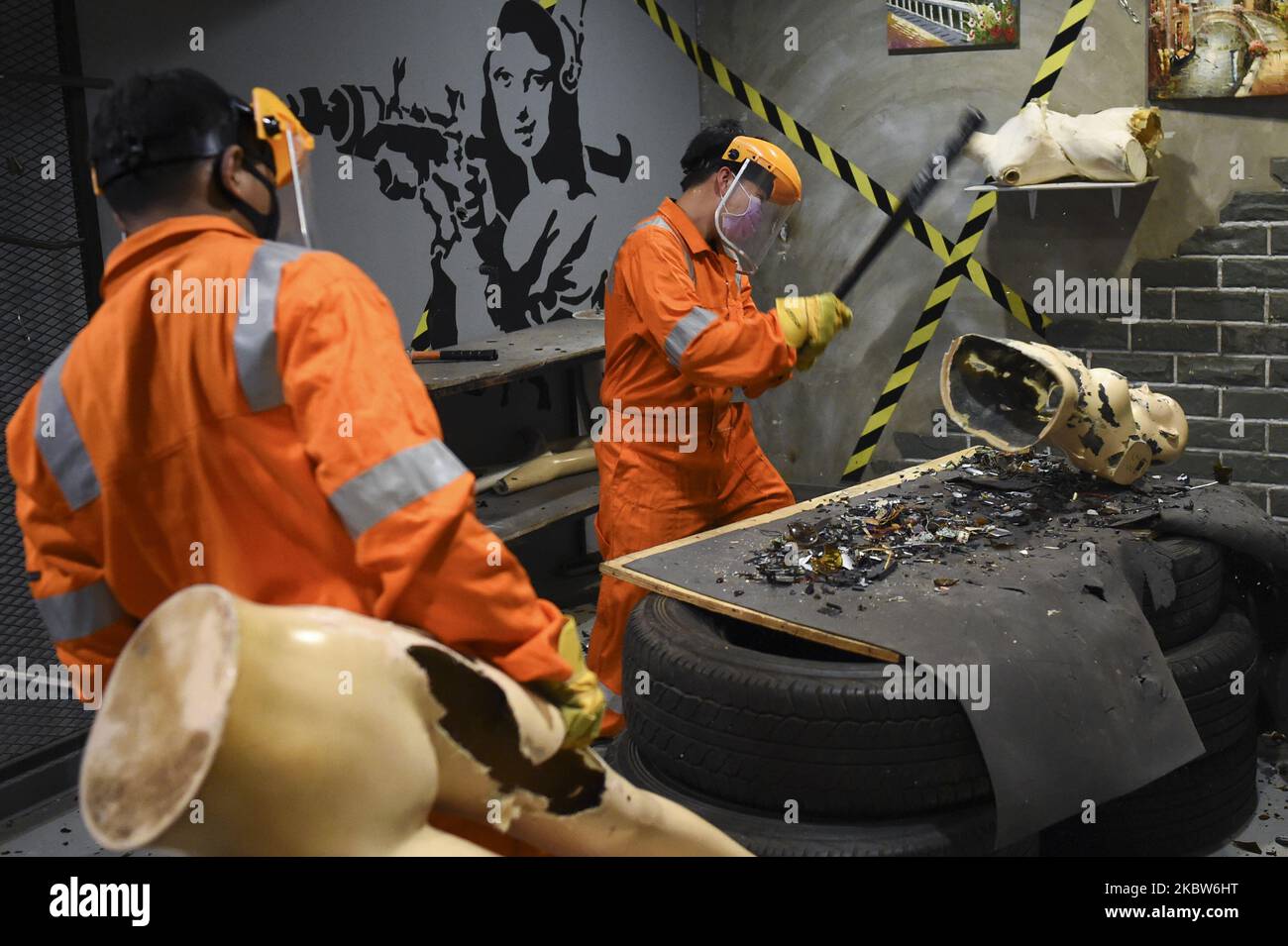 People take part in a "Rage Room" smashes a mannequin to vent anger and ...