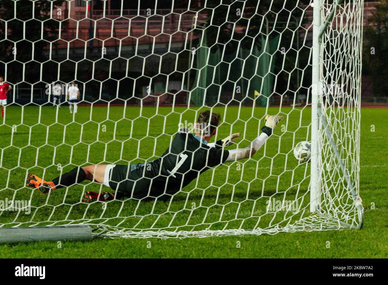 goalkeeper hits ball during football match Stock Photo - Alamy