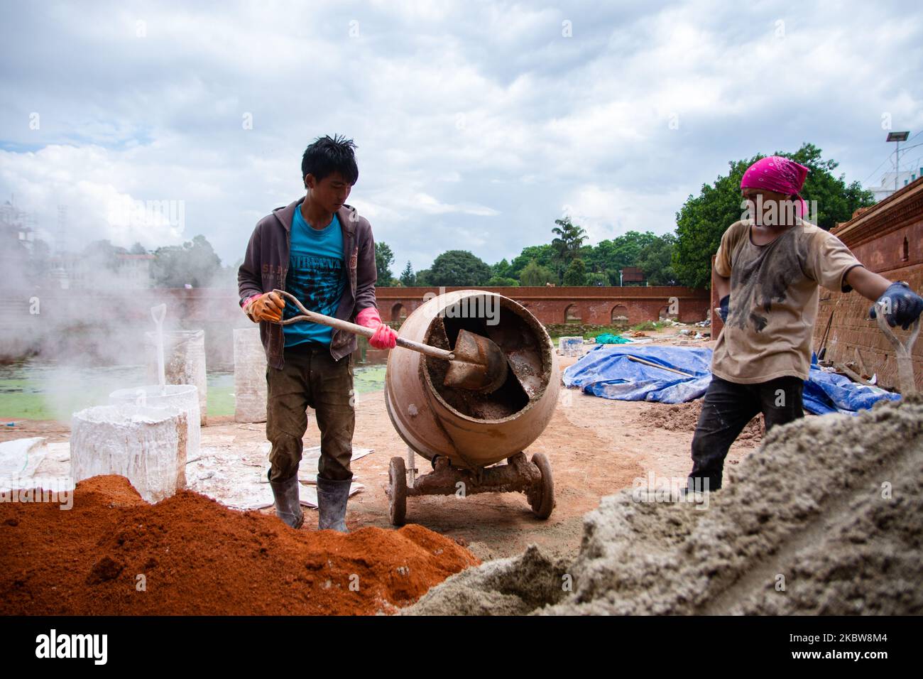 Nepalese workers working at a construction site of Rani Pokhari which ...
