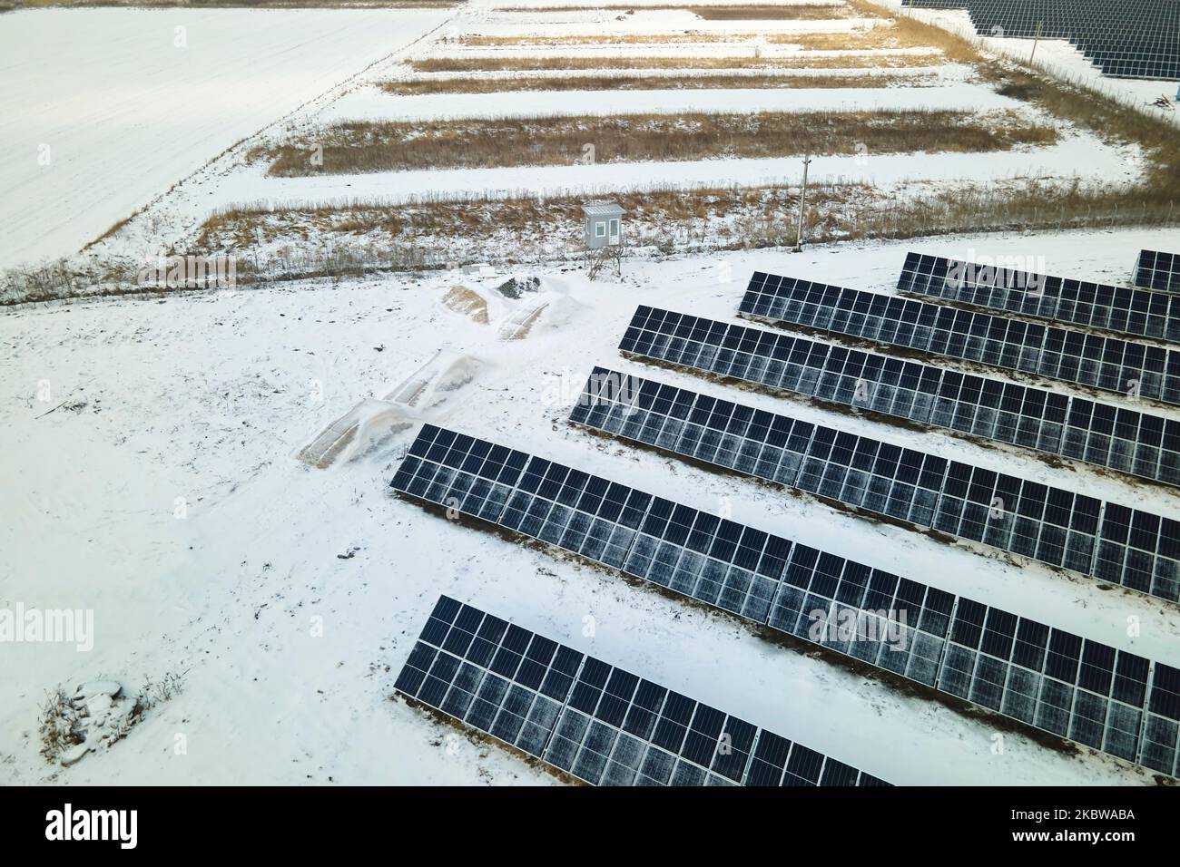 Aerial view of electrical power plant with solar panels covered with ...