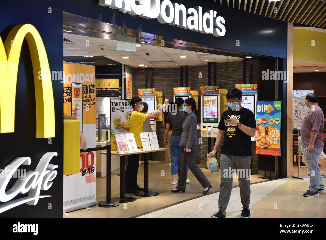A customer has his temperature taken before entering Mc Donald's in the ...