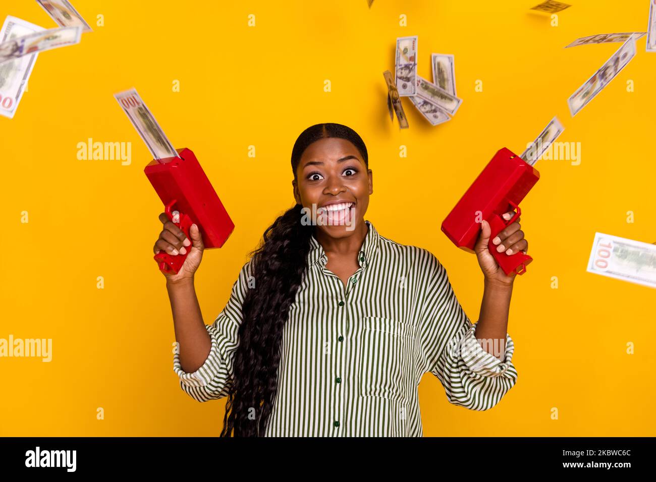Portrait of positive funky lady hold money gun throw banknotes usd ...