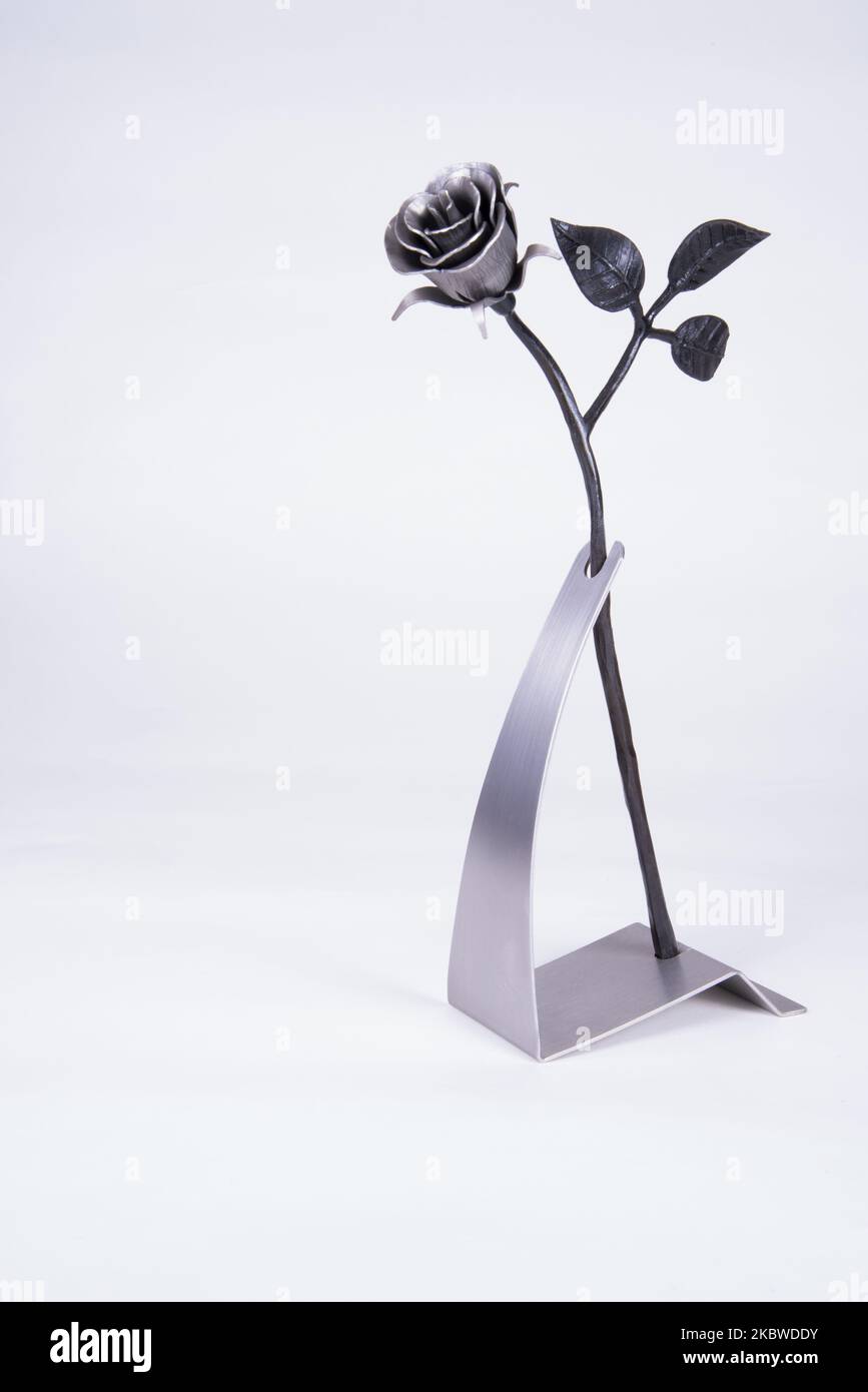 Hand forged wrought iron rose in a flower stand Stock Photo - Alamy