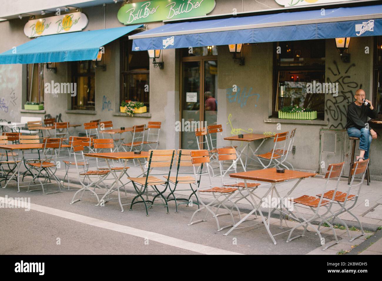 Tables are seen in the middle of parking area within white lines as ...