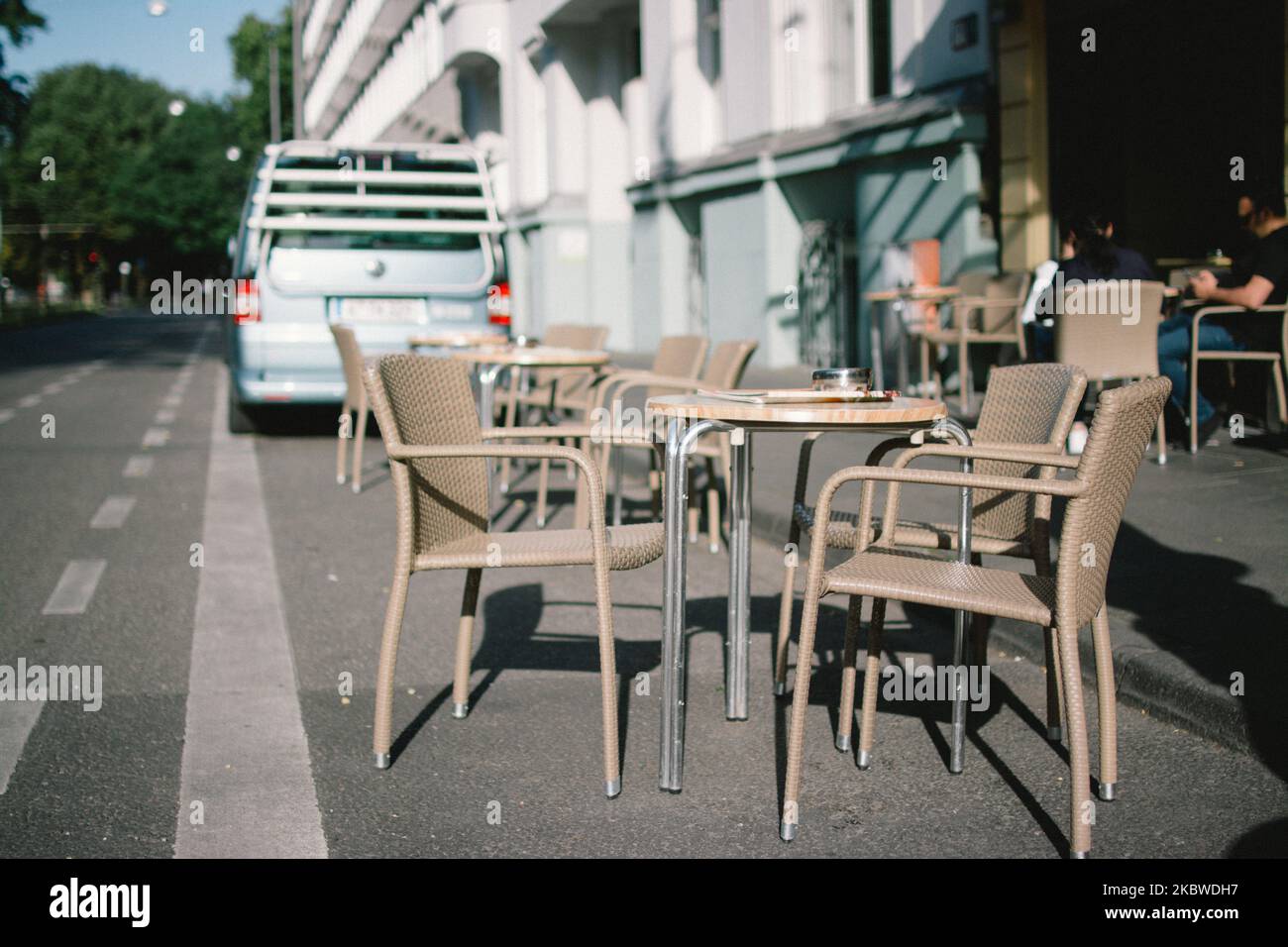 Tables are seen in the middle of parking area within white lines as ...