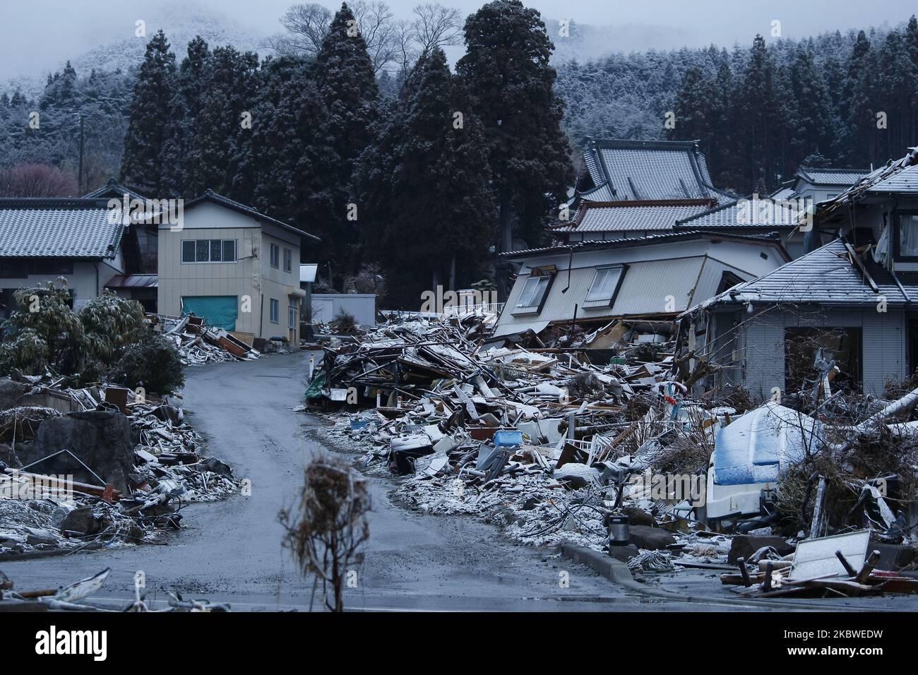 March 24, 2011-Sanriku, Japan-Snow falling on debris and mud covered at ...