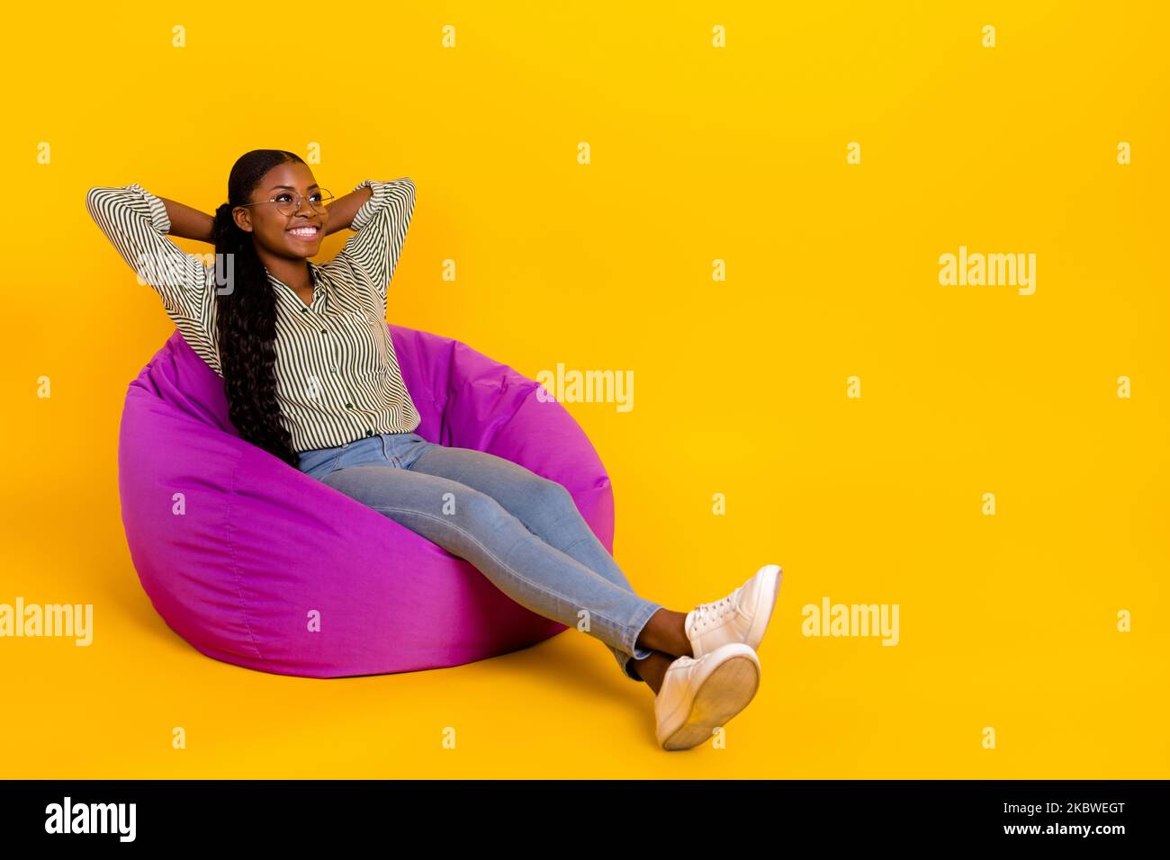Full body portrait of pretty positive girl sit comfy bag look empty ...
